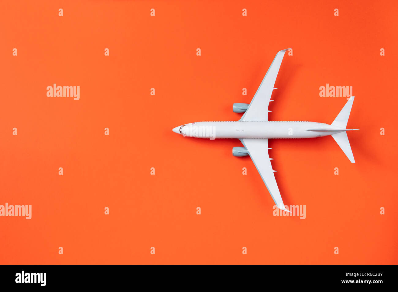 Image of airplane isolated on empty red background Stock Photo - Alamy
