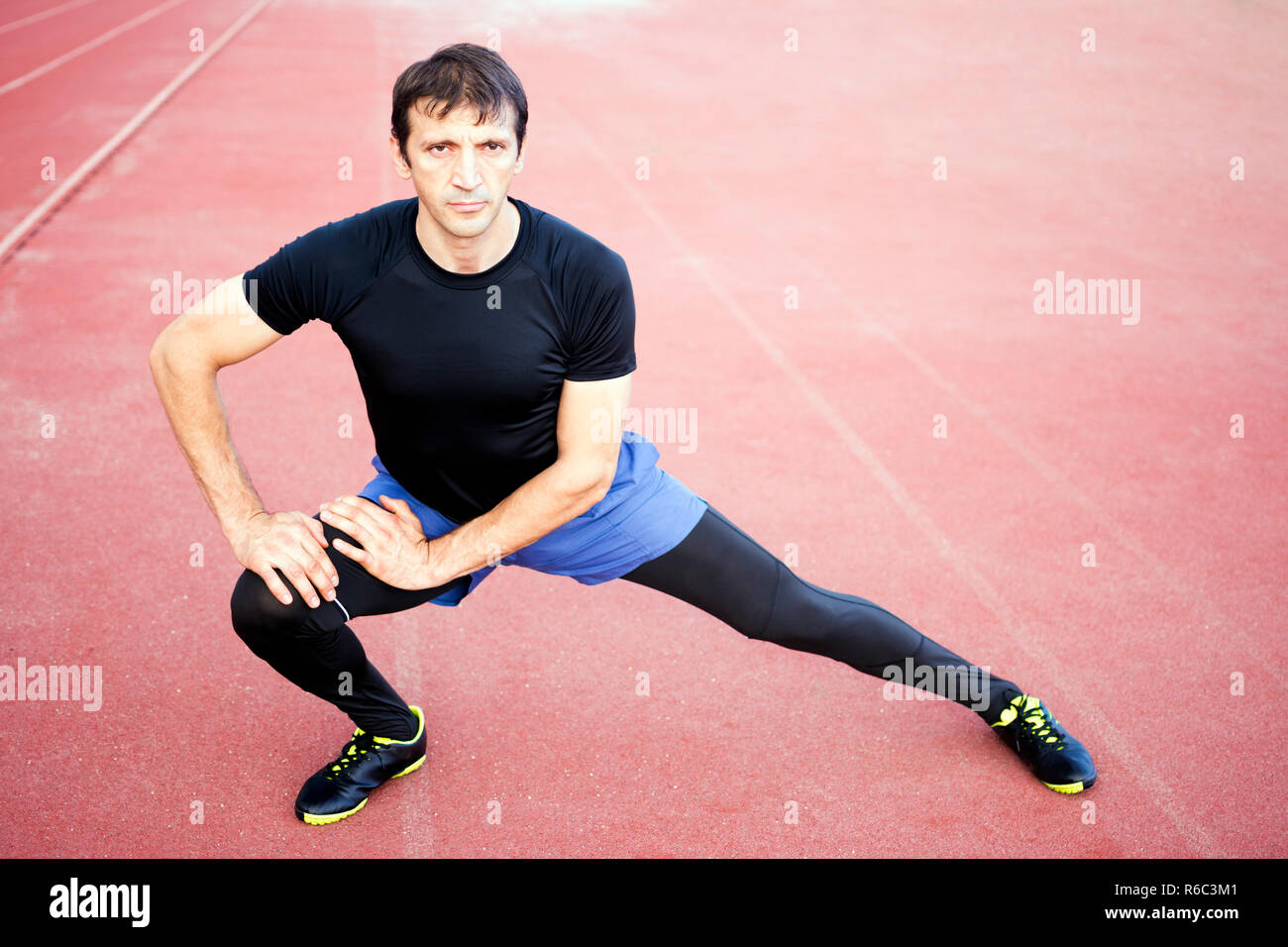 exercising and stretching in stadium Stock Photo - Alamy