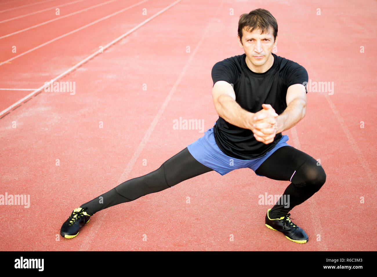 exercising and stretching in stadium Stock Photo - Alamy