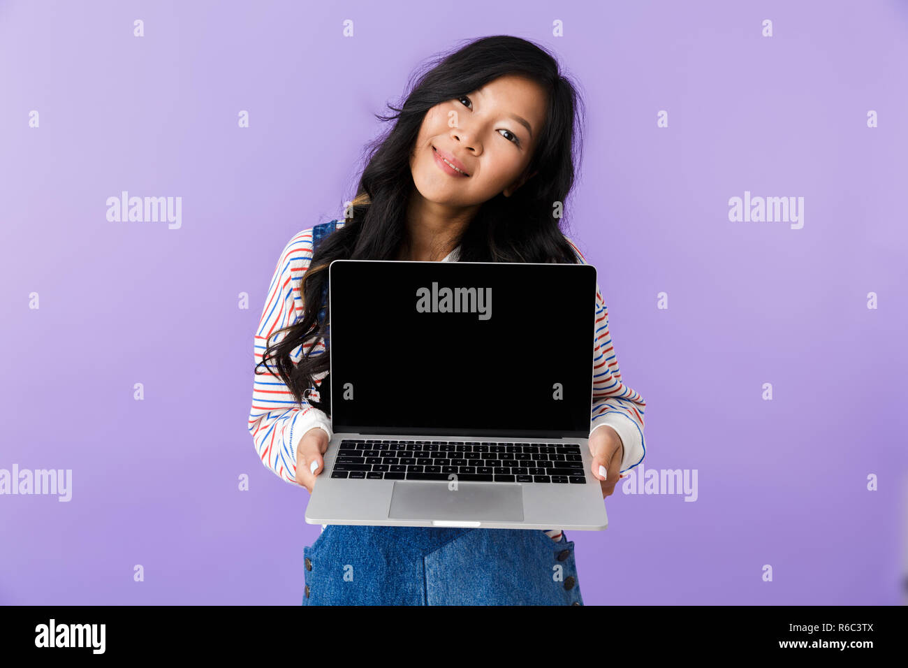 Image of a happy asian woman posing isolated over purple wall ...