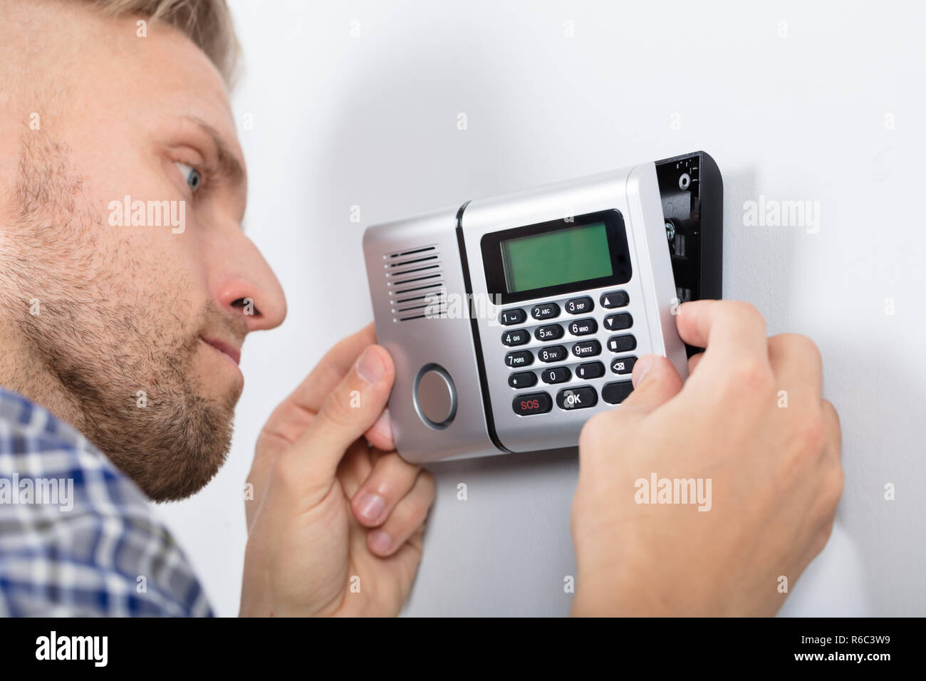 Repairman Installing Security System Stock Photo - Alamy
