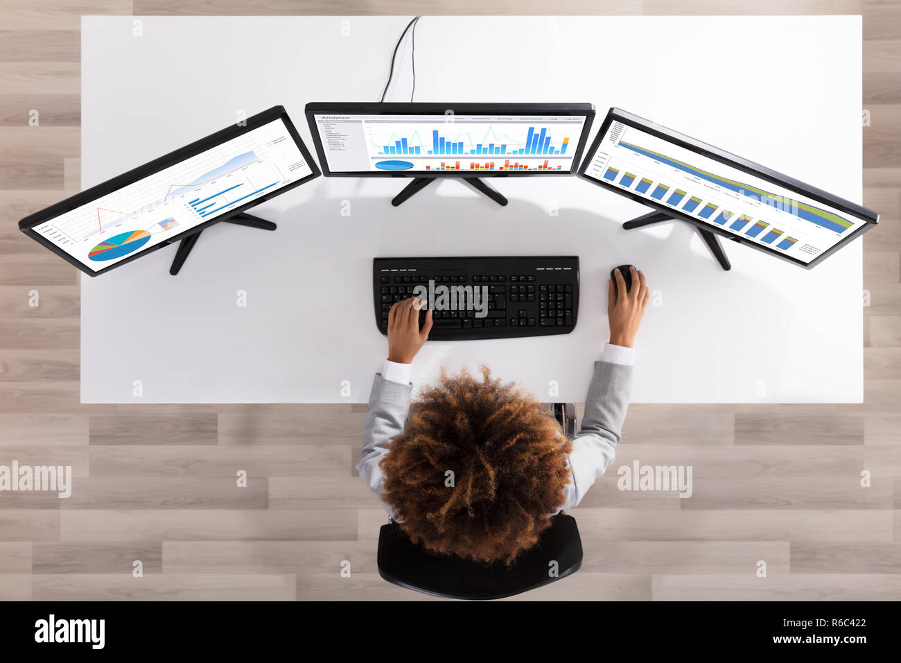 Businesswoman Analyzing Graph On Multiple Computers Stock Photo - Alamy