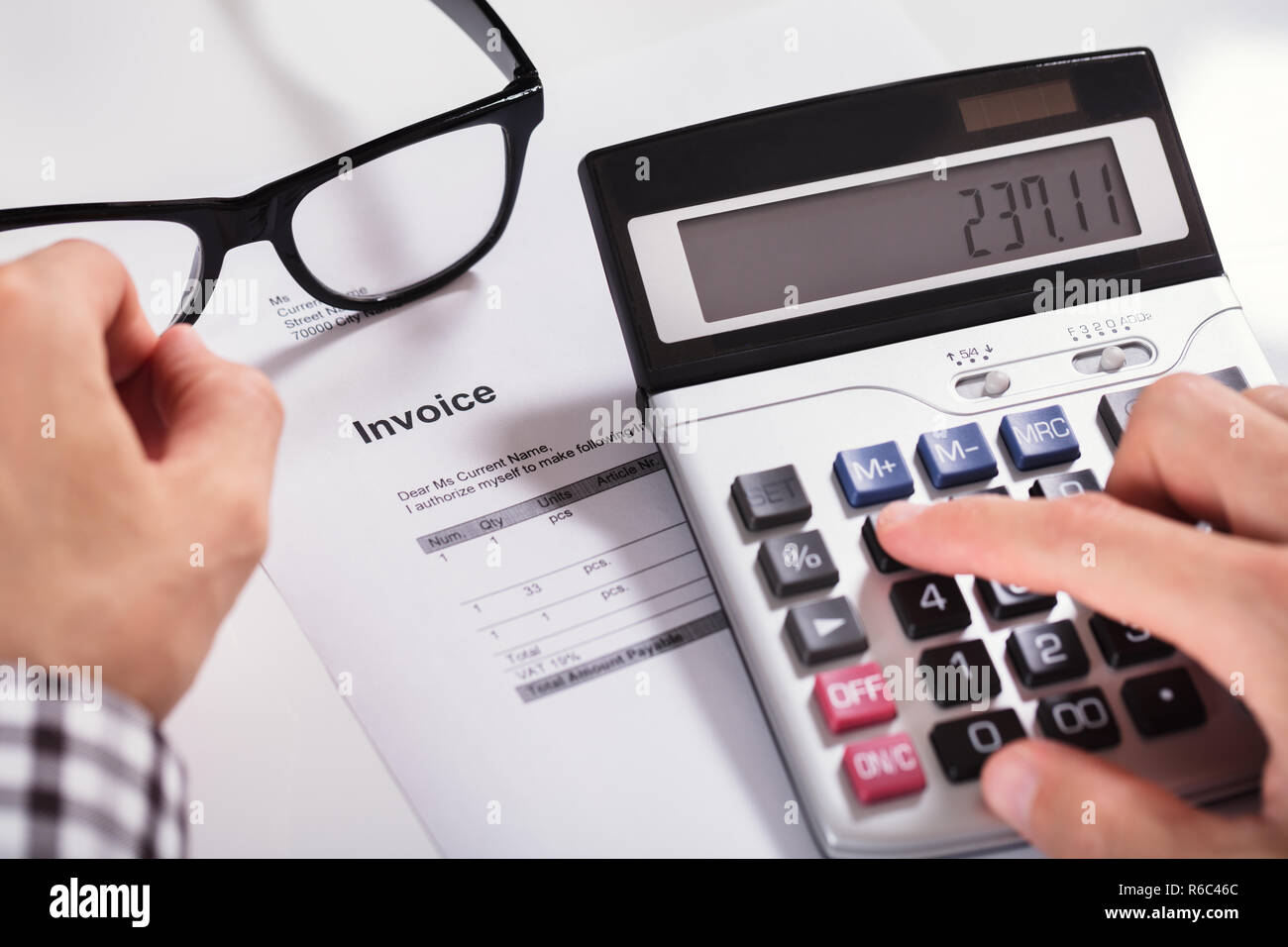 Businessman's Hands Calculating Invoice Stock Photo - Alamy
