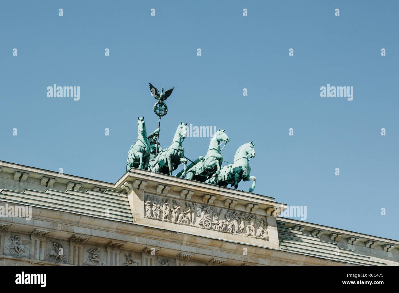 Closeup of the Brandenburg Gate against the blue sky. This is one of ...