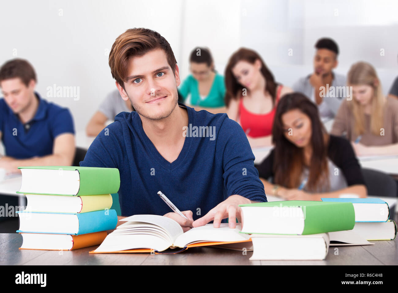 Young Man Studying In Classroom Stock Photo - Alamy