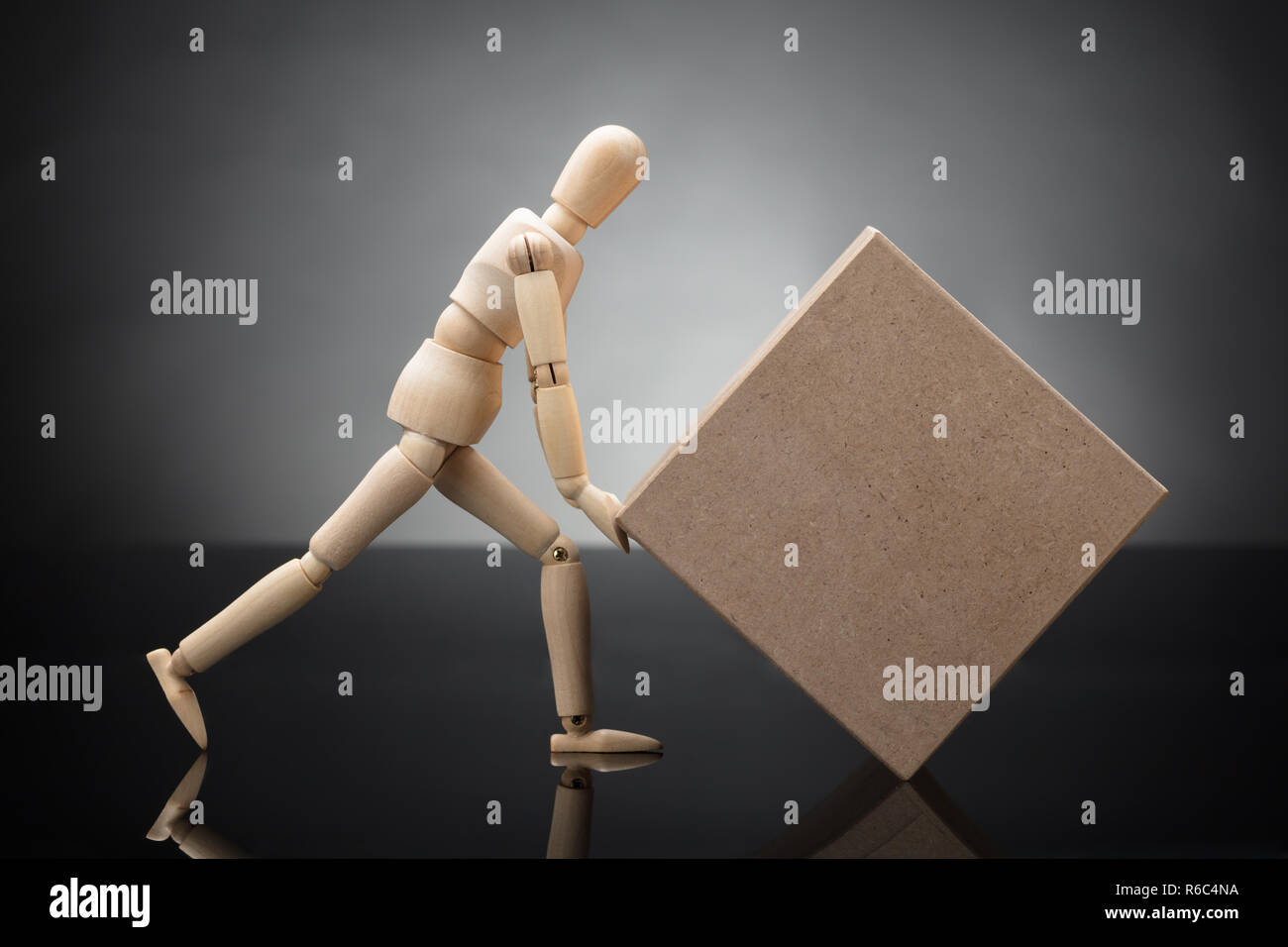 Wooden Dummy Lifting Cardboard Box Stock Photo - Alamy