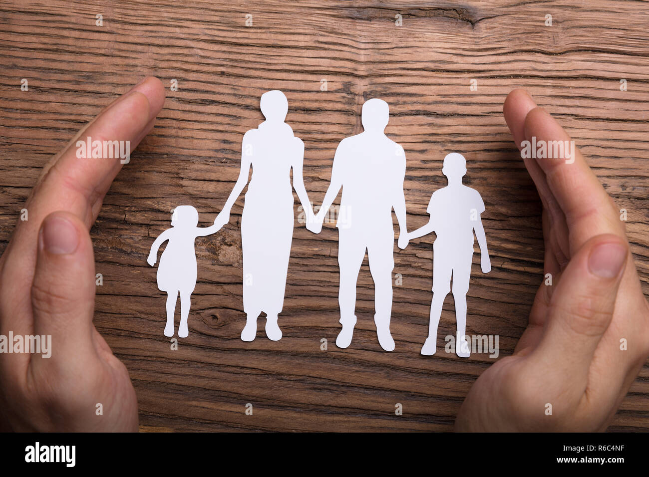 Person Hand Protecting Family Papercut Stock Photo - Alamy