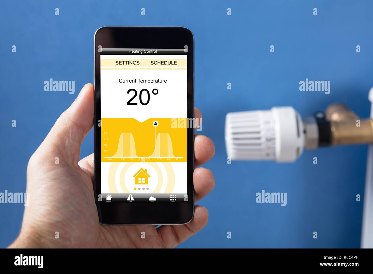 Person Hand Setting Temperature Of Thermostat Using Mobilephone Stock ...