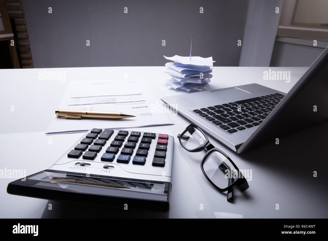 Documents With Calculator And Laptop Stock Photo - Alamy