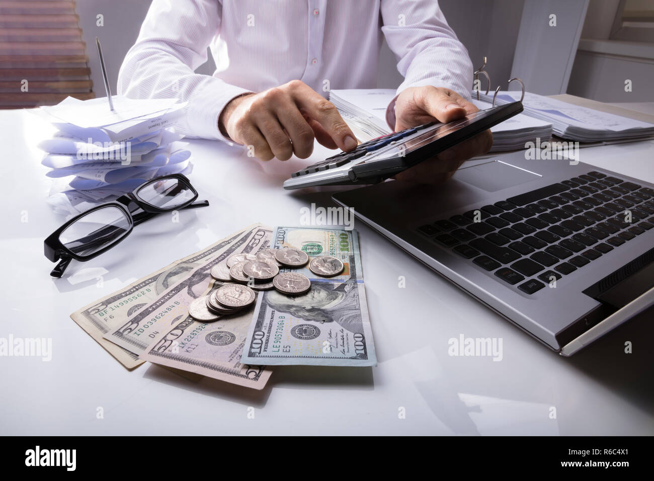 Accountant calculating dollars calculator hi-res stock photography and ...