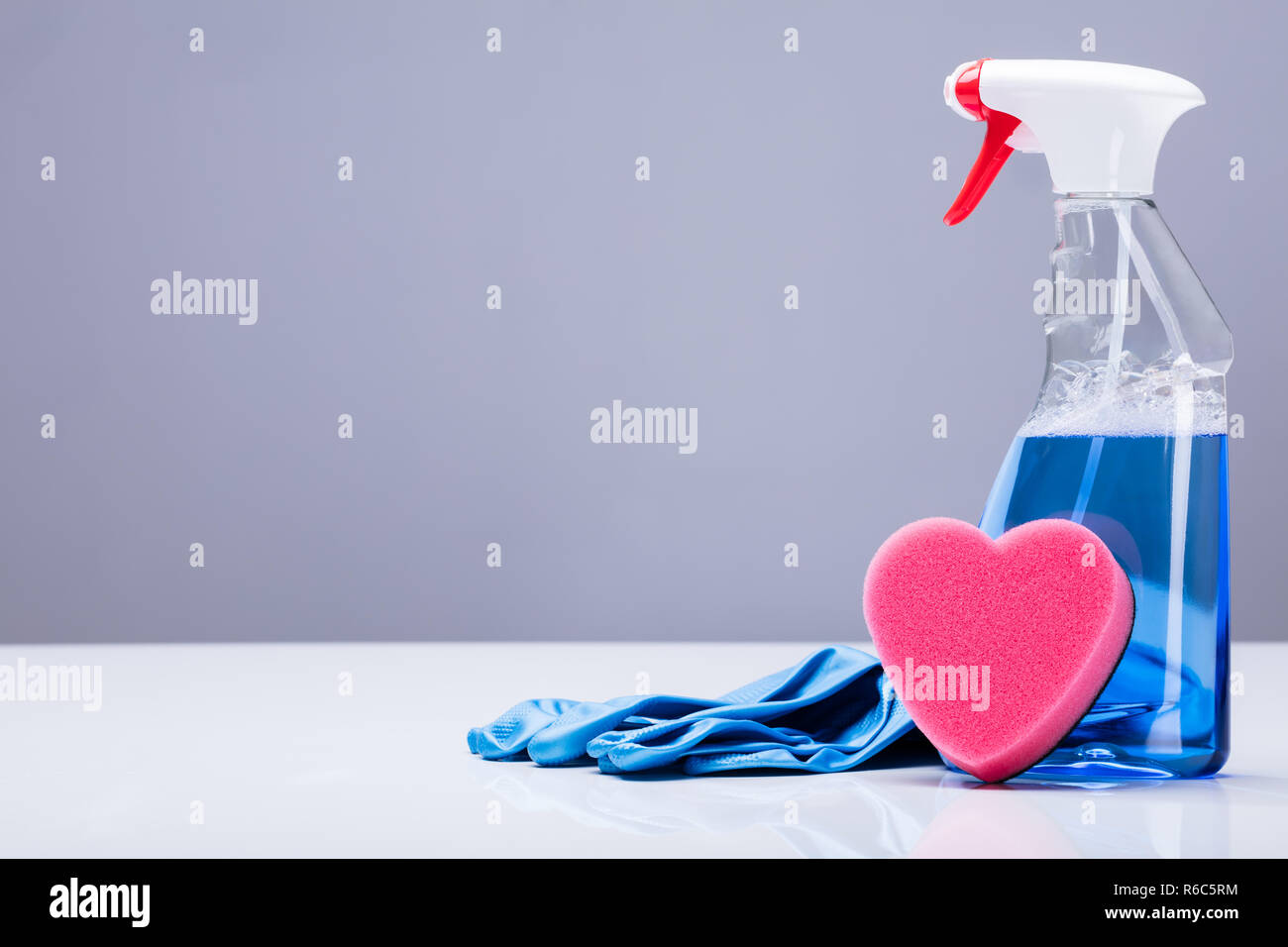 Cleaning Spray, Rubber Gloves And Heart Shape Sponge Stock Photo - Alamy