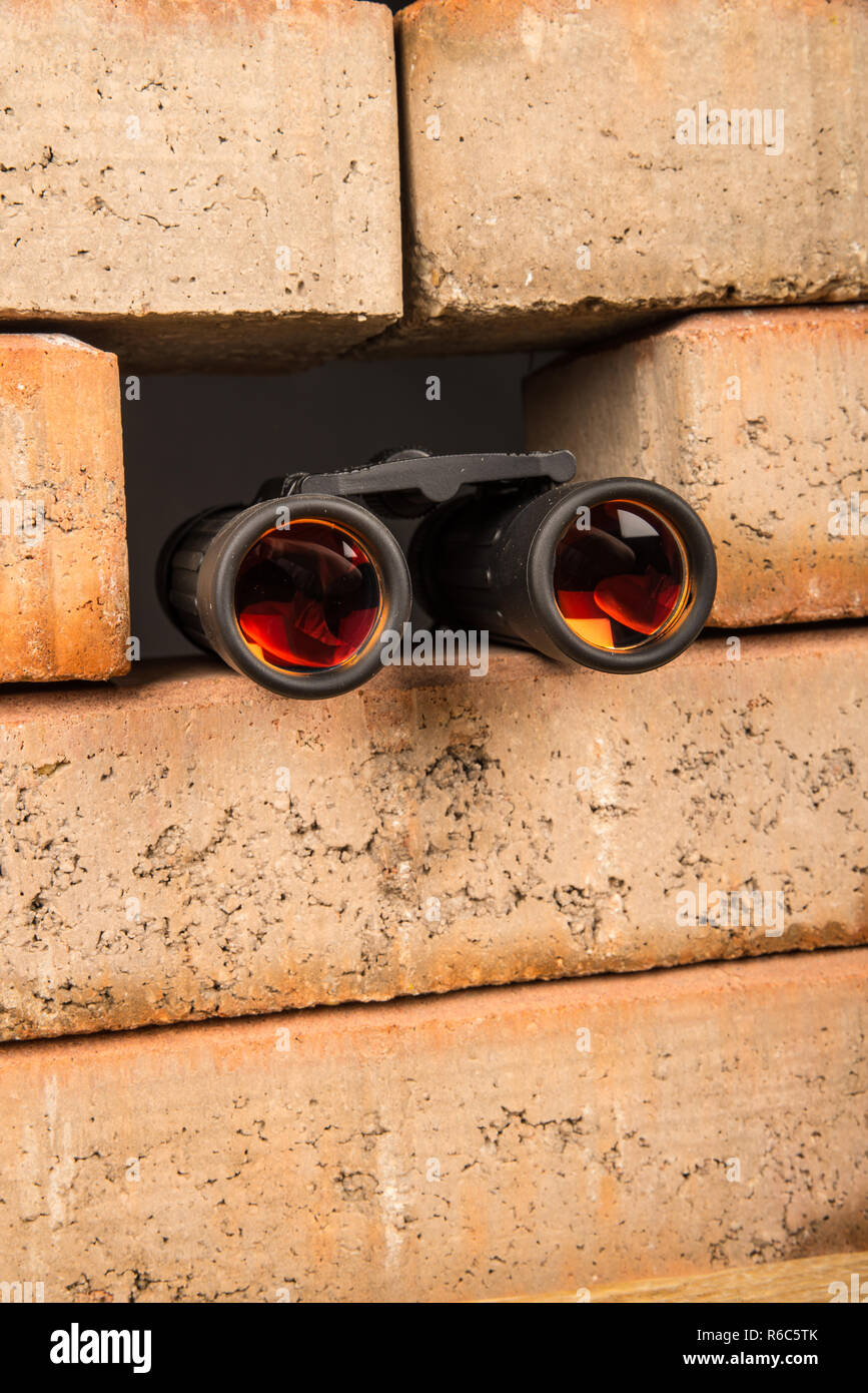 Spy glass sticking out of a wall, an immigration concept Stock Photo ...