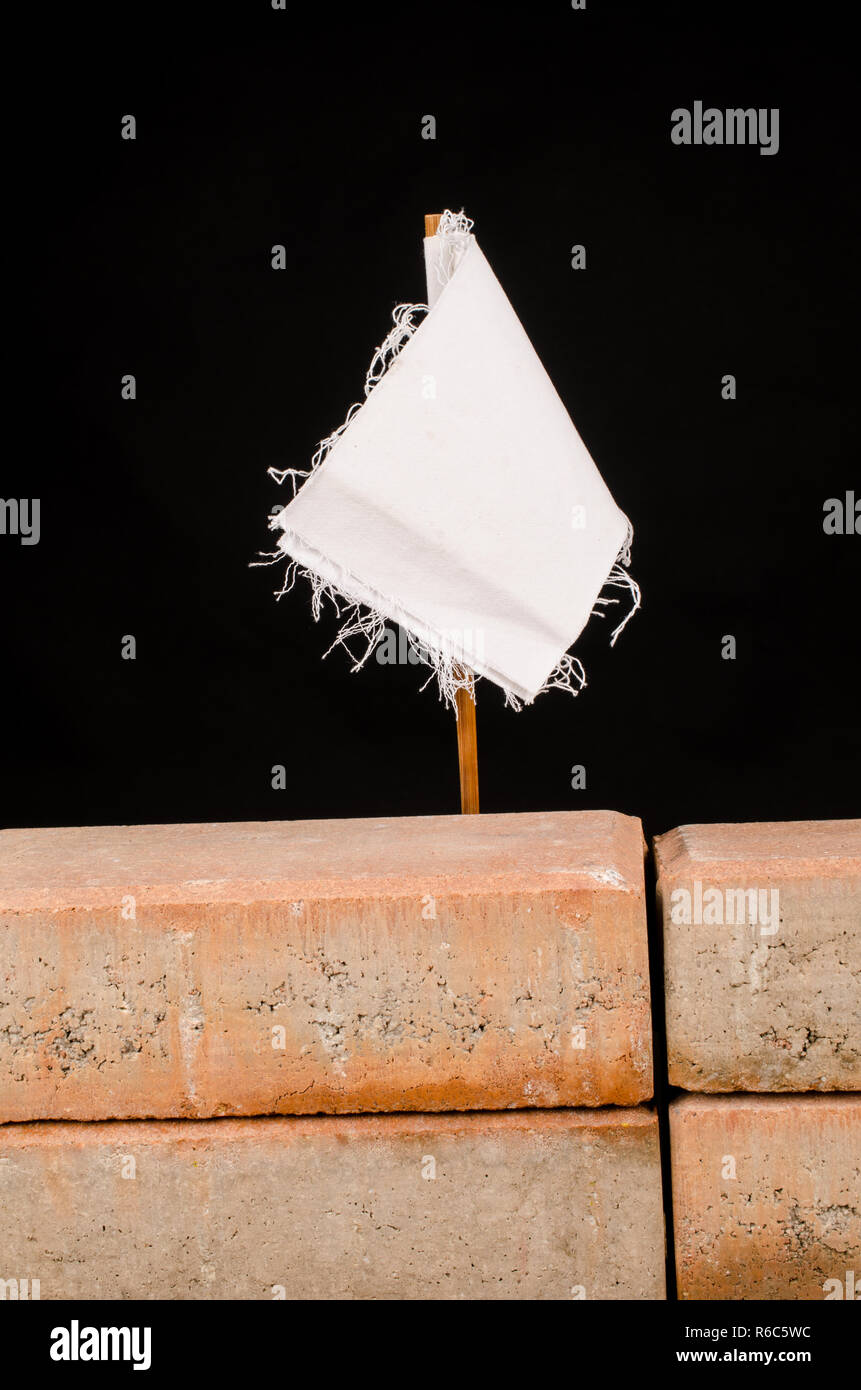 White flag on a wall, a multiple concept both on overworking and on ...