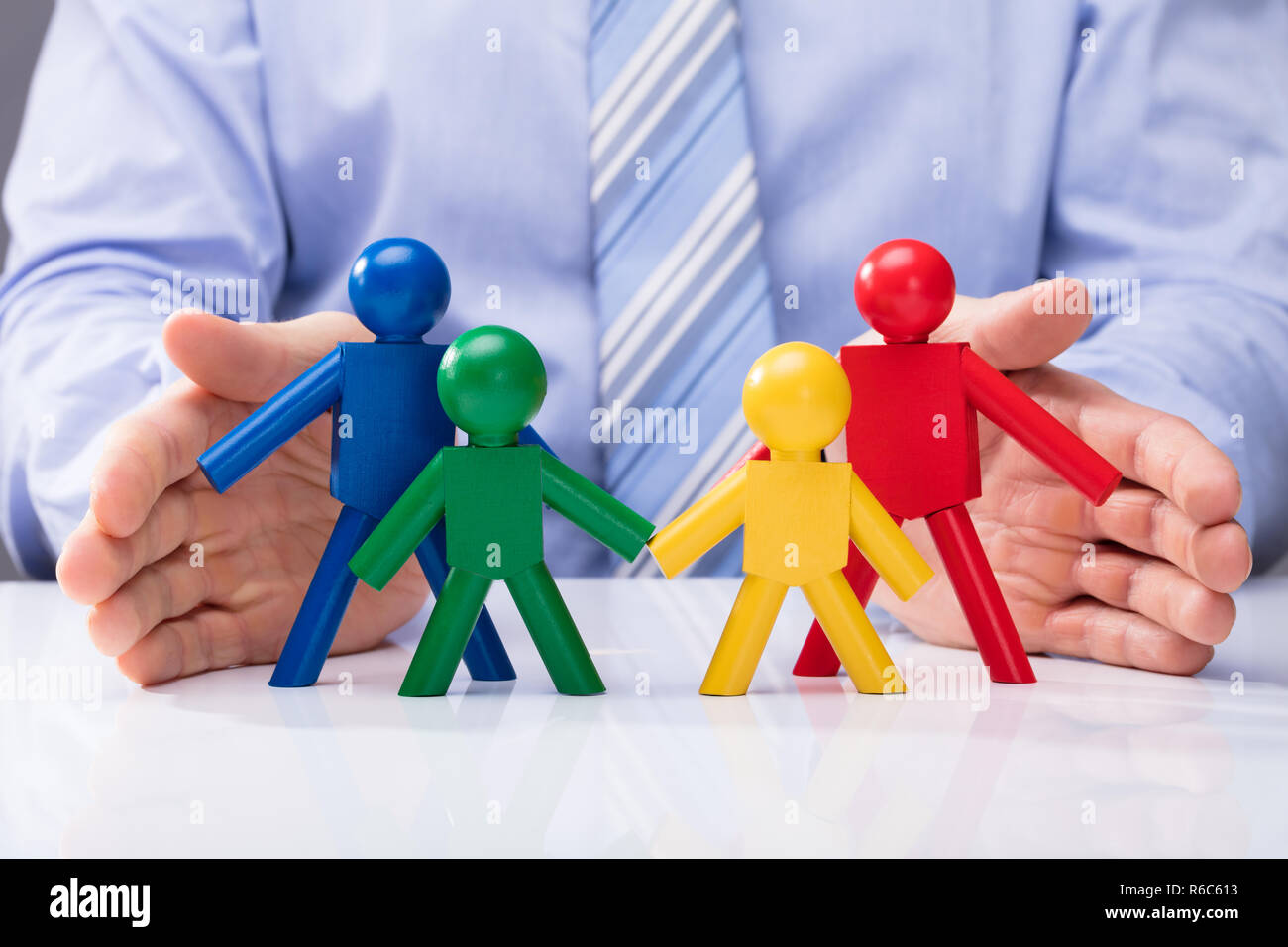 Human Hand Protecting Human Figures Stock Photo - Alamy