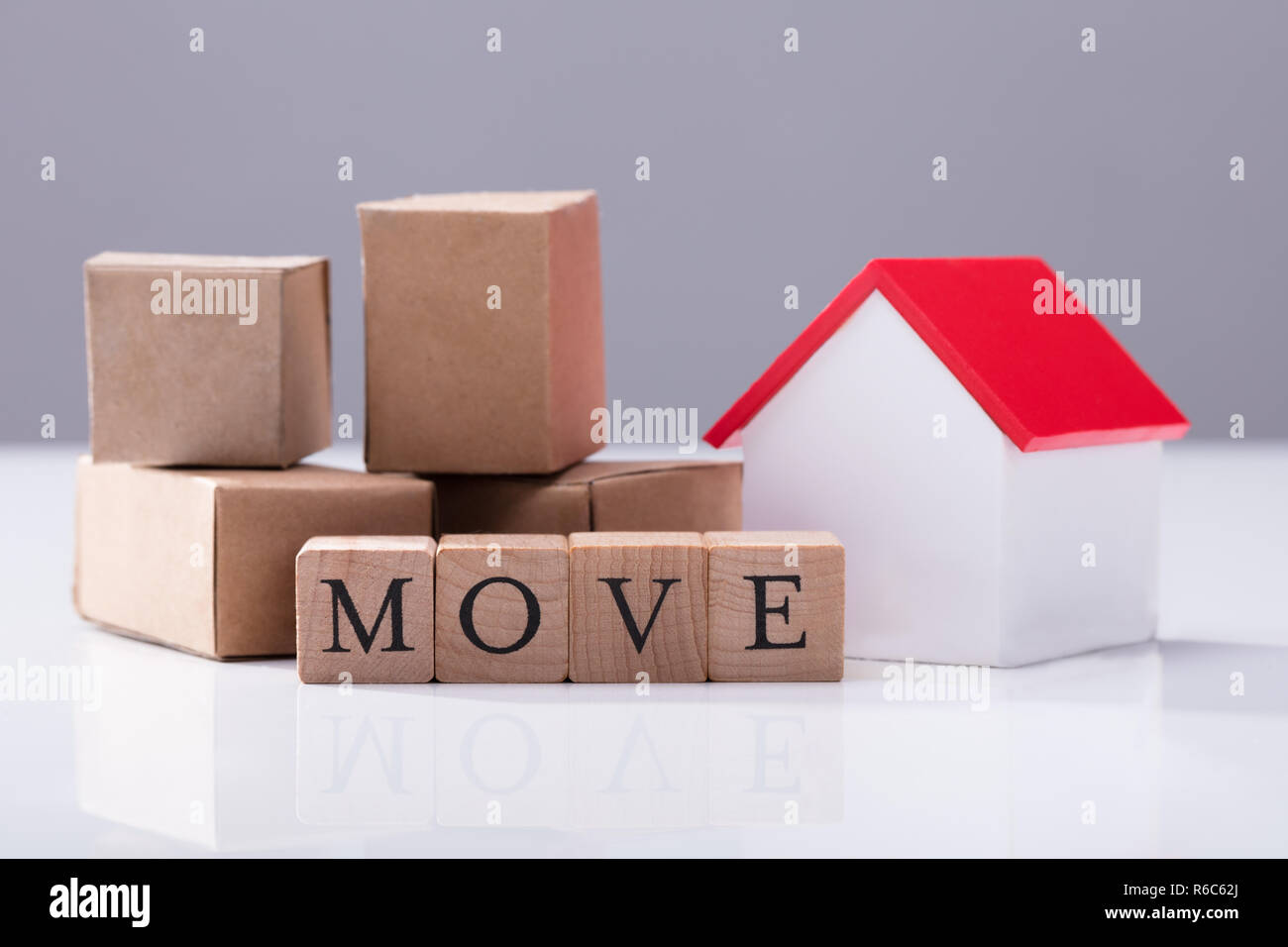 Move Text In Front Of Cardboard Boxes And House Model Stock Photo - Alamy