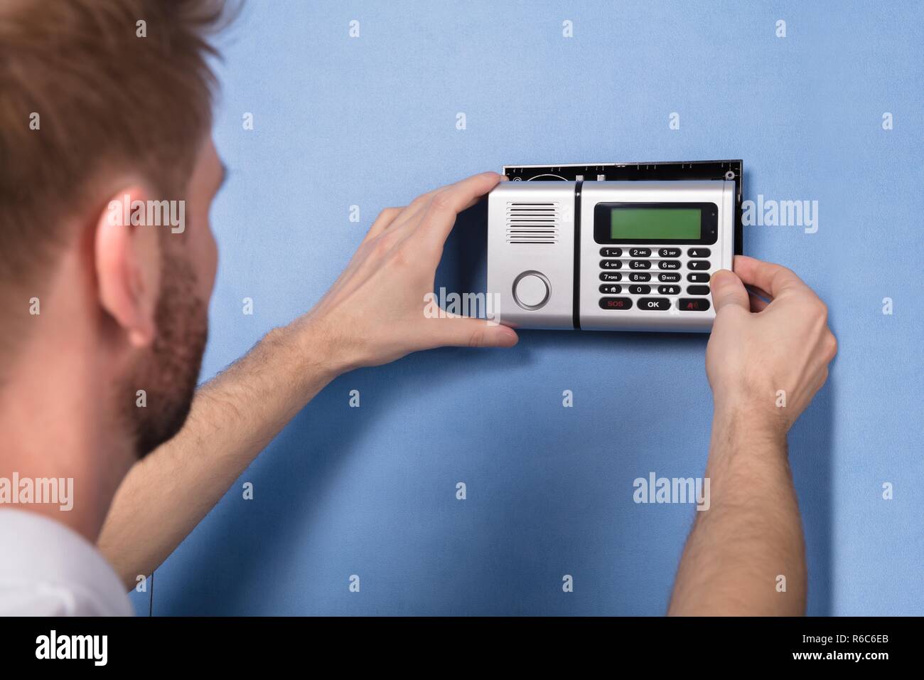 Human Hand Installing Security System Stock Photo - Alamy