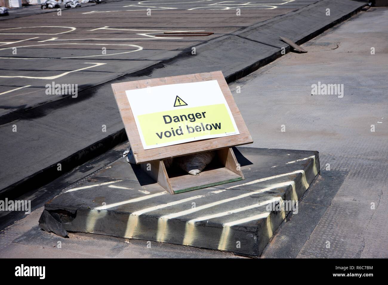 Danger void below sign on construction site Stock Photo - Alamy