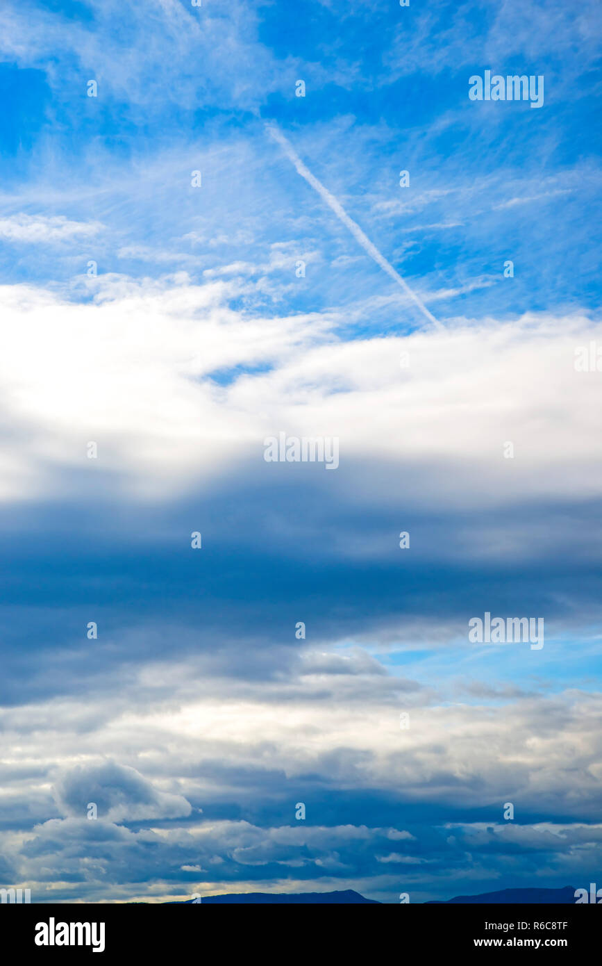 Blue Sky With Layers Of Clouds Stock Photo - Alamy