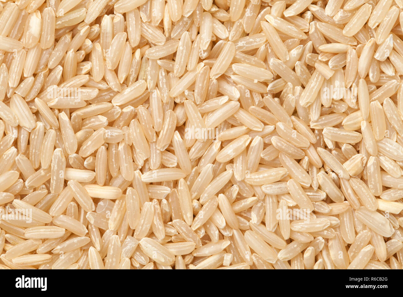 long grain brown rice background Stock Photo - Alamy