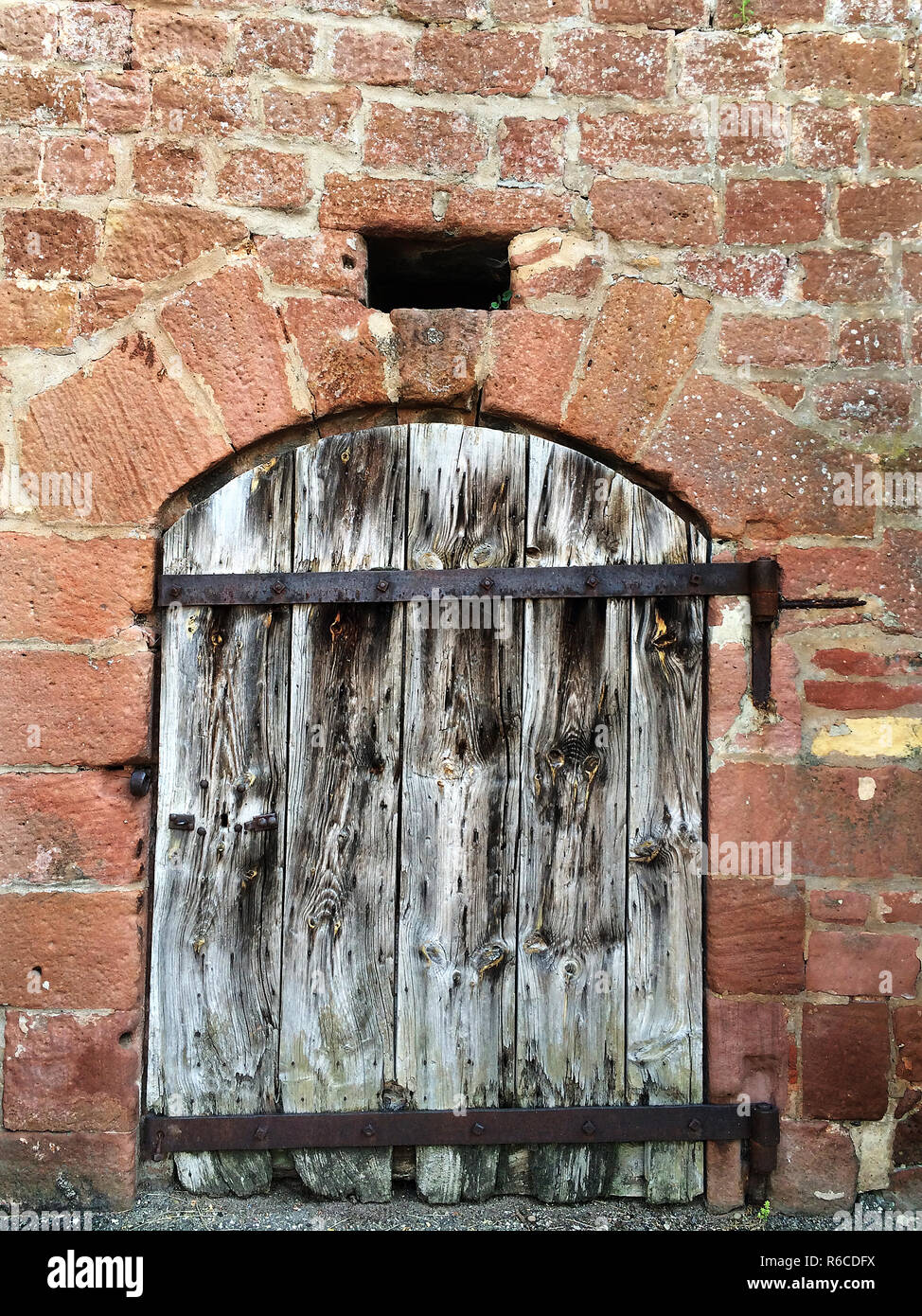 Medieval Wall With Wooden Door Stock Photo - Alamy