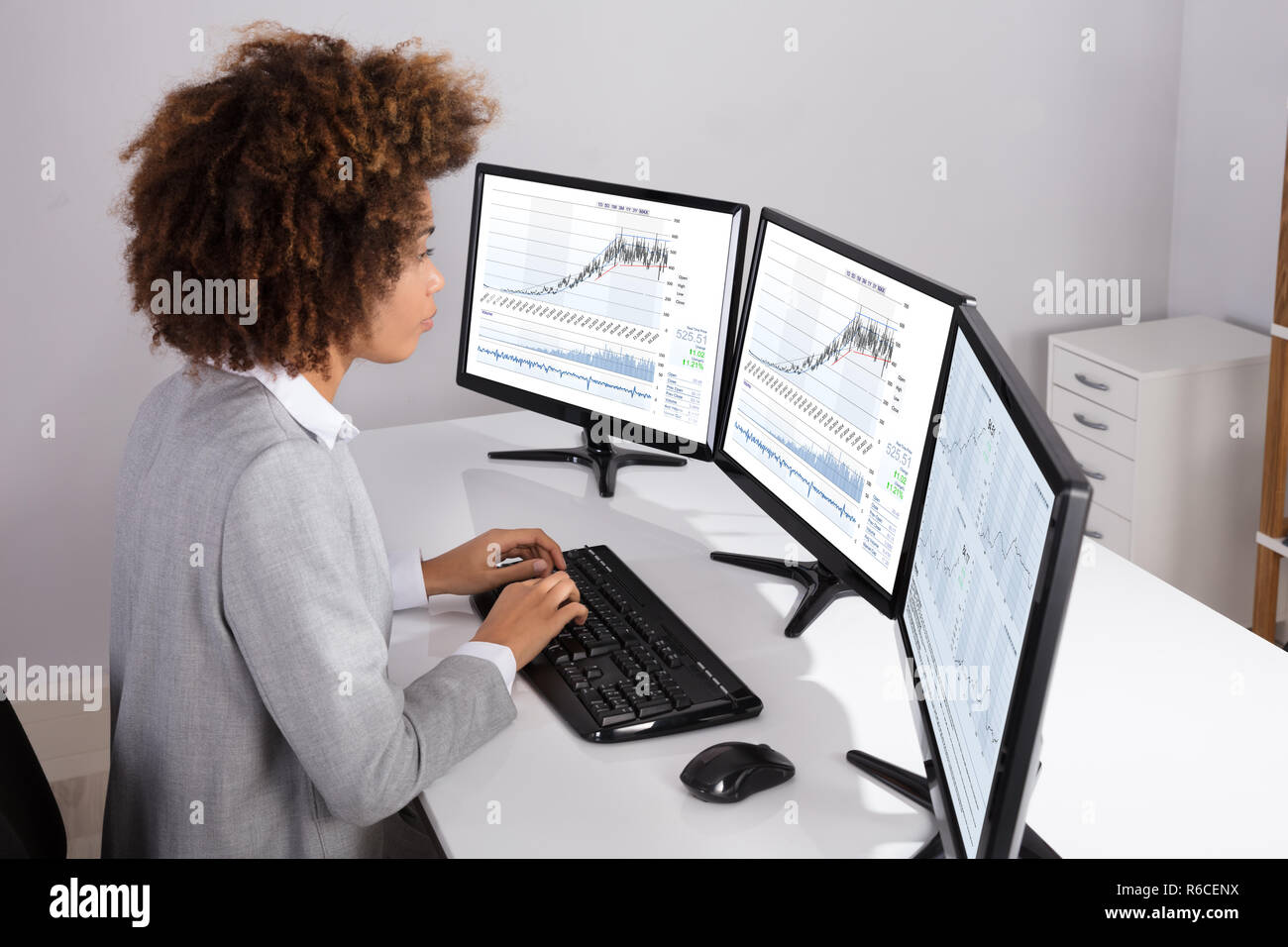 Young businesswoman analyzing charts using hi-res stock photography and ...