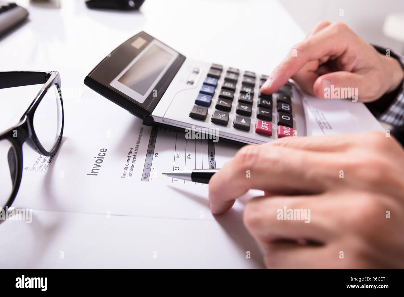 Businessman's Hands Calculating Invoice Stock Photo - Alamy