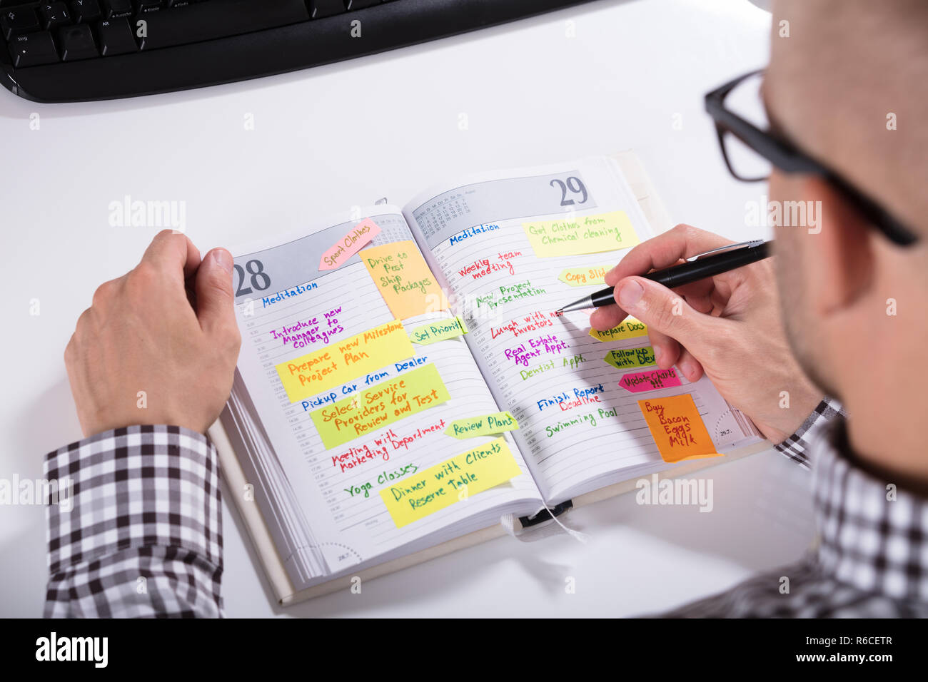 Man Writing Important Notes In Diary Stock Photo - Alamy