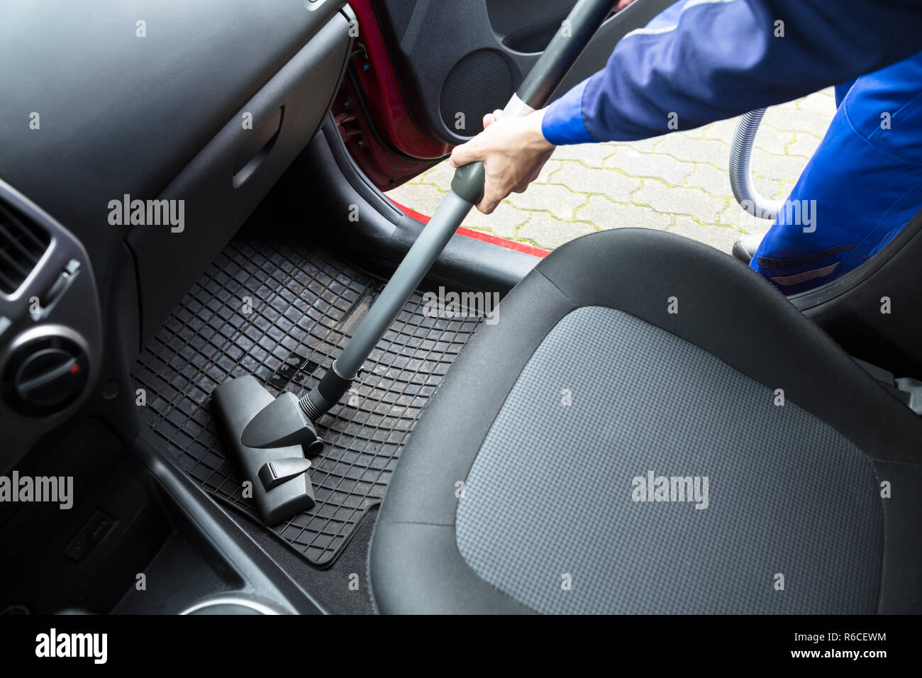 Handyman's Hand Vacuuming Car Mat Stock Photo - Alamy