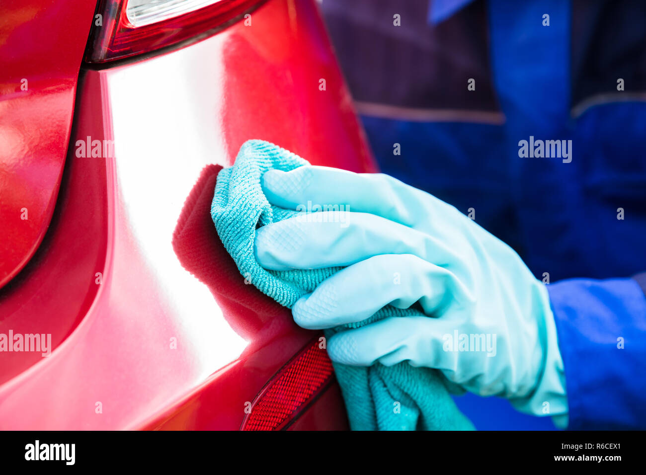 Happy Male Worker Cleaning Red Car Stock Photo - Alamy