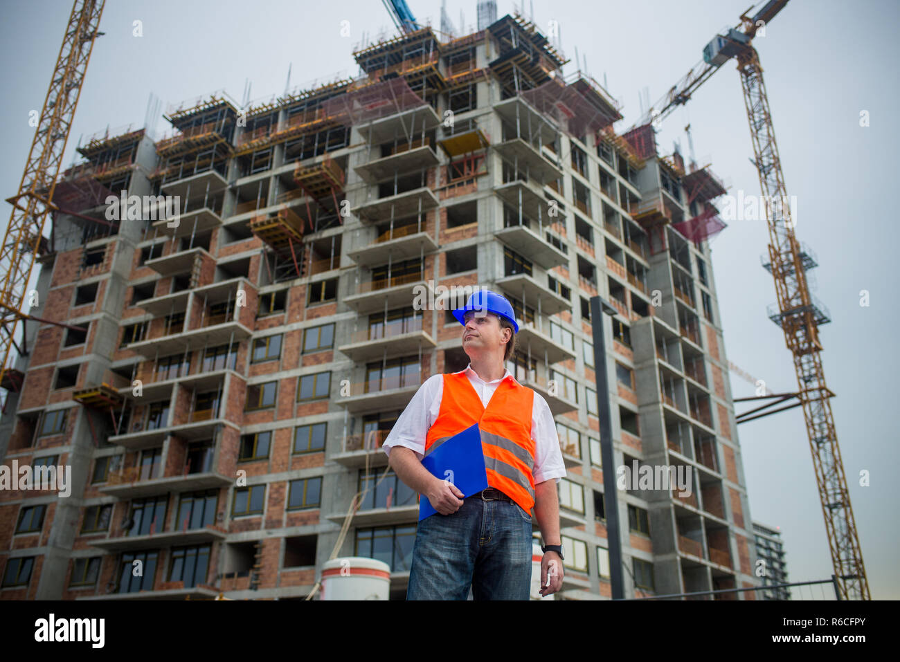 Architect on a construction site during a housing project Stock Photo ...