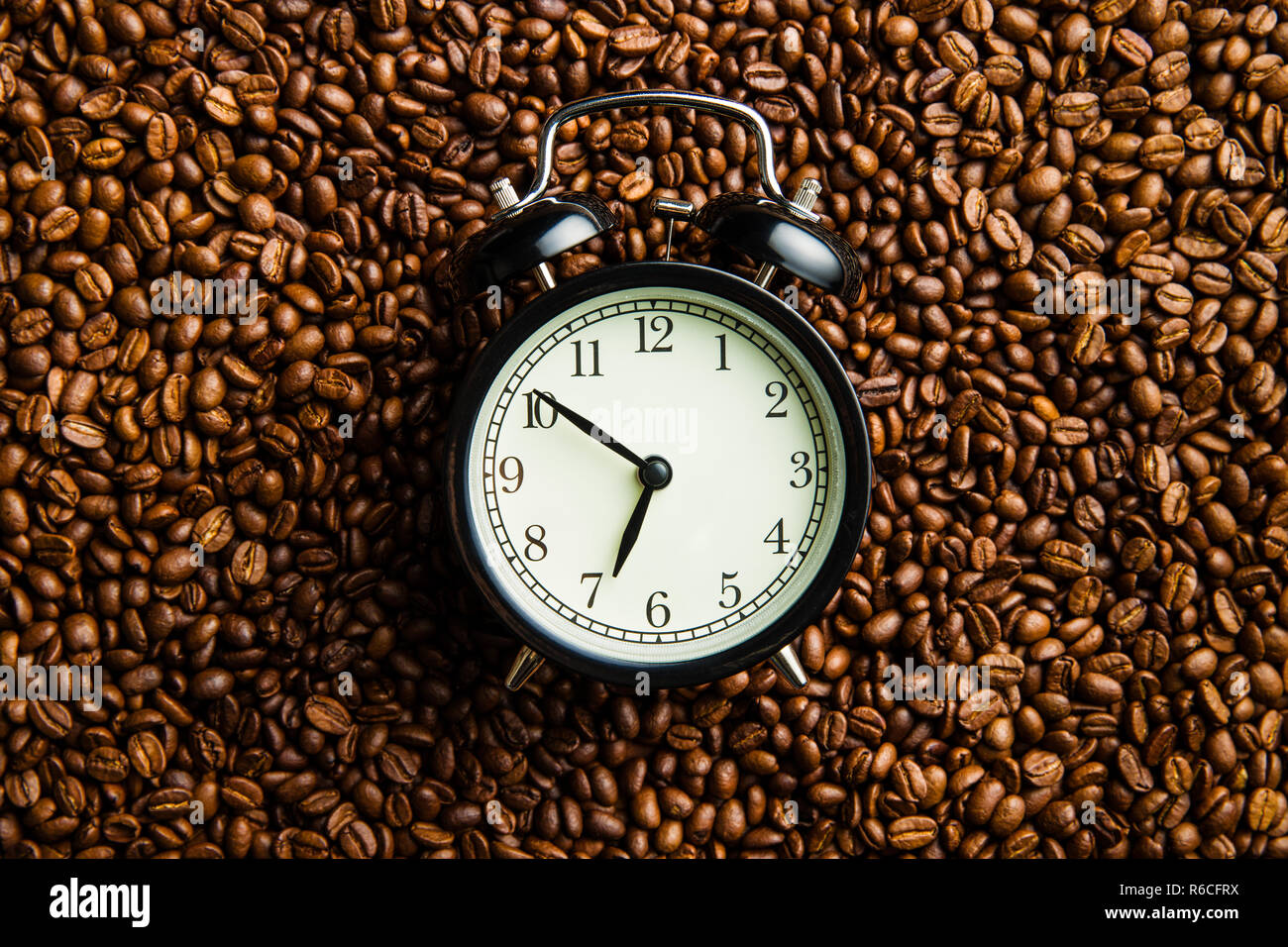 vintage alarm clock and coffee beans Stock Photo - Alamy