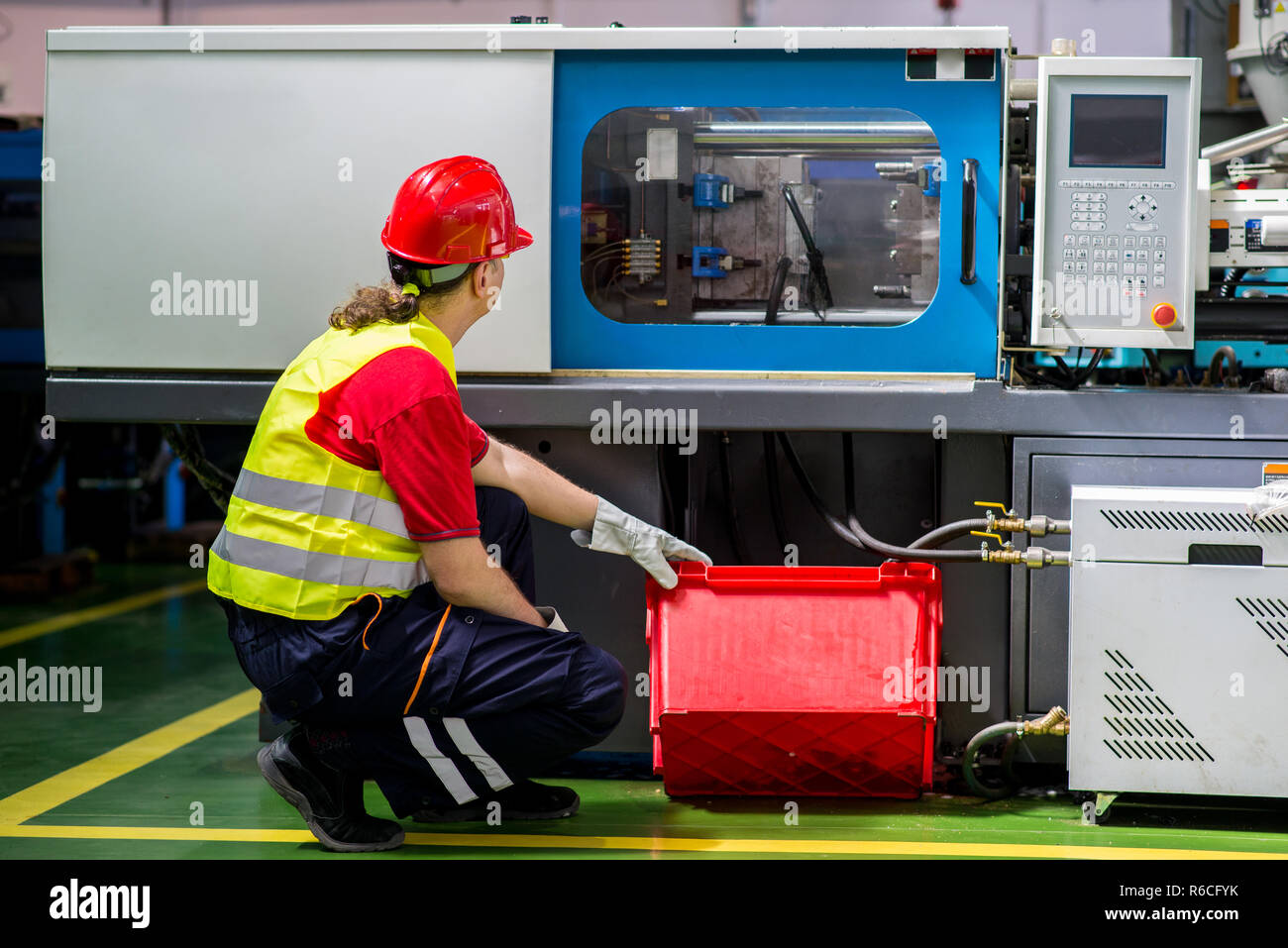 Factory worker maintaining a factory machine Stock Photo - Alamy