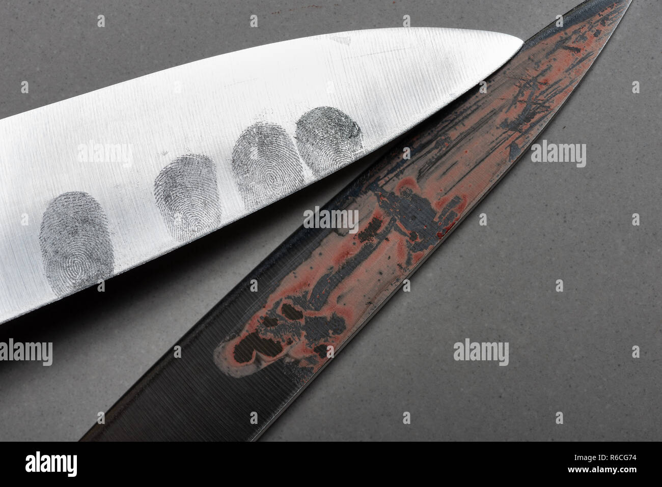 Dusted finger prints showing up as forensic eveidence on a sharp steel ...