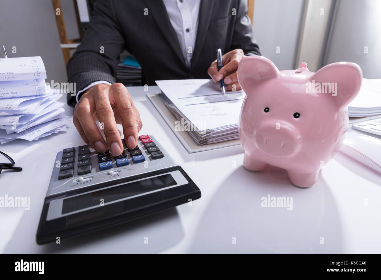 Businessperson Calculating Bill With Calculator Stock Photo - Alamy