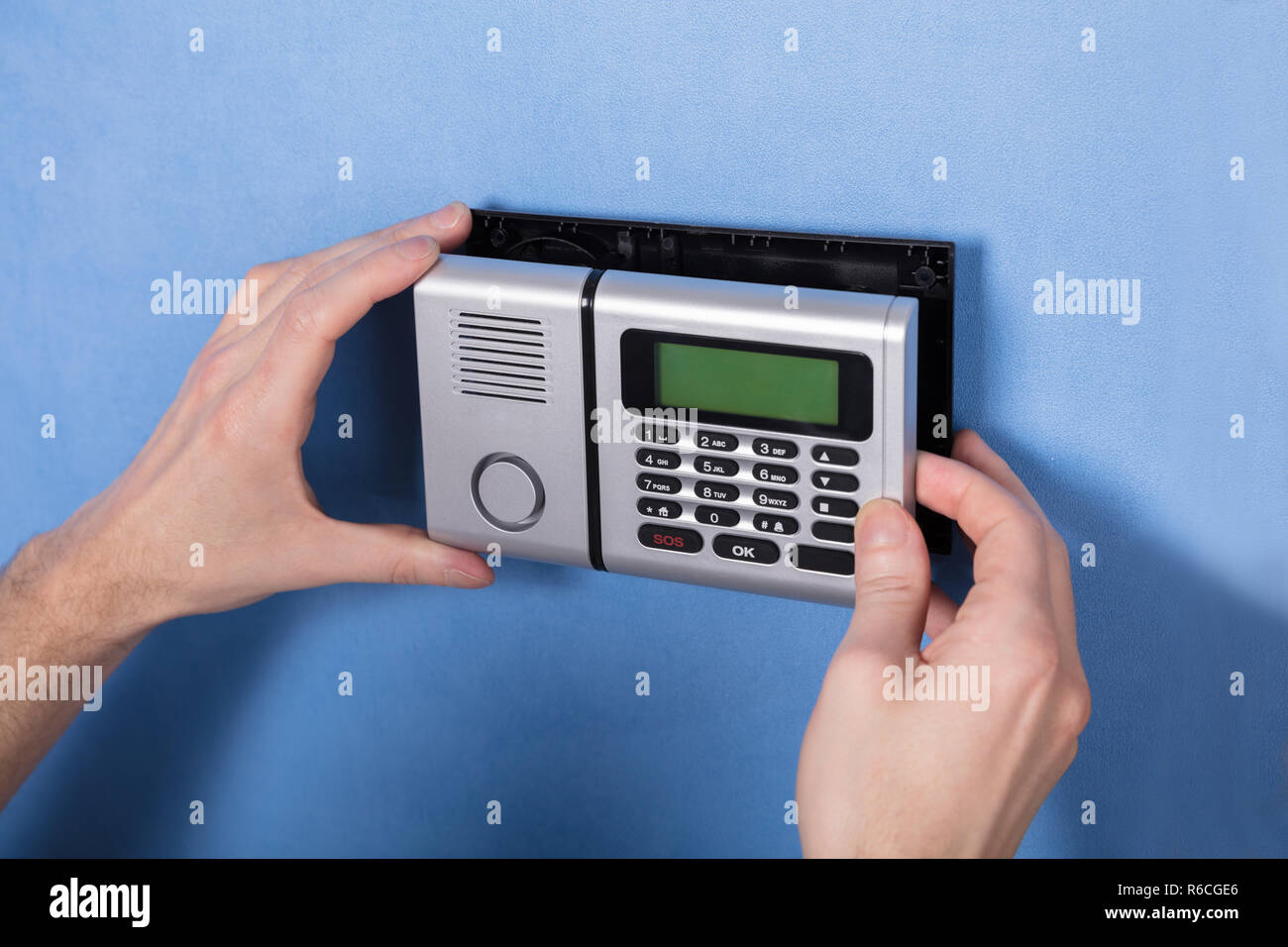 Human Hand Installing Security System Stock Photo - Alamy