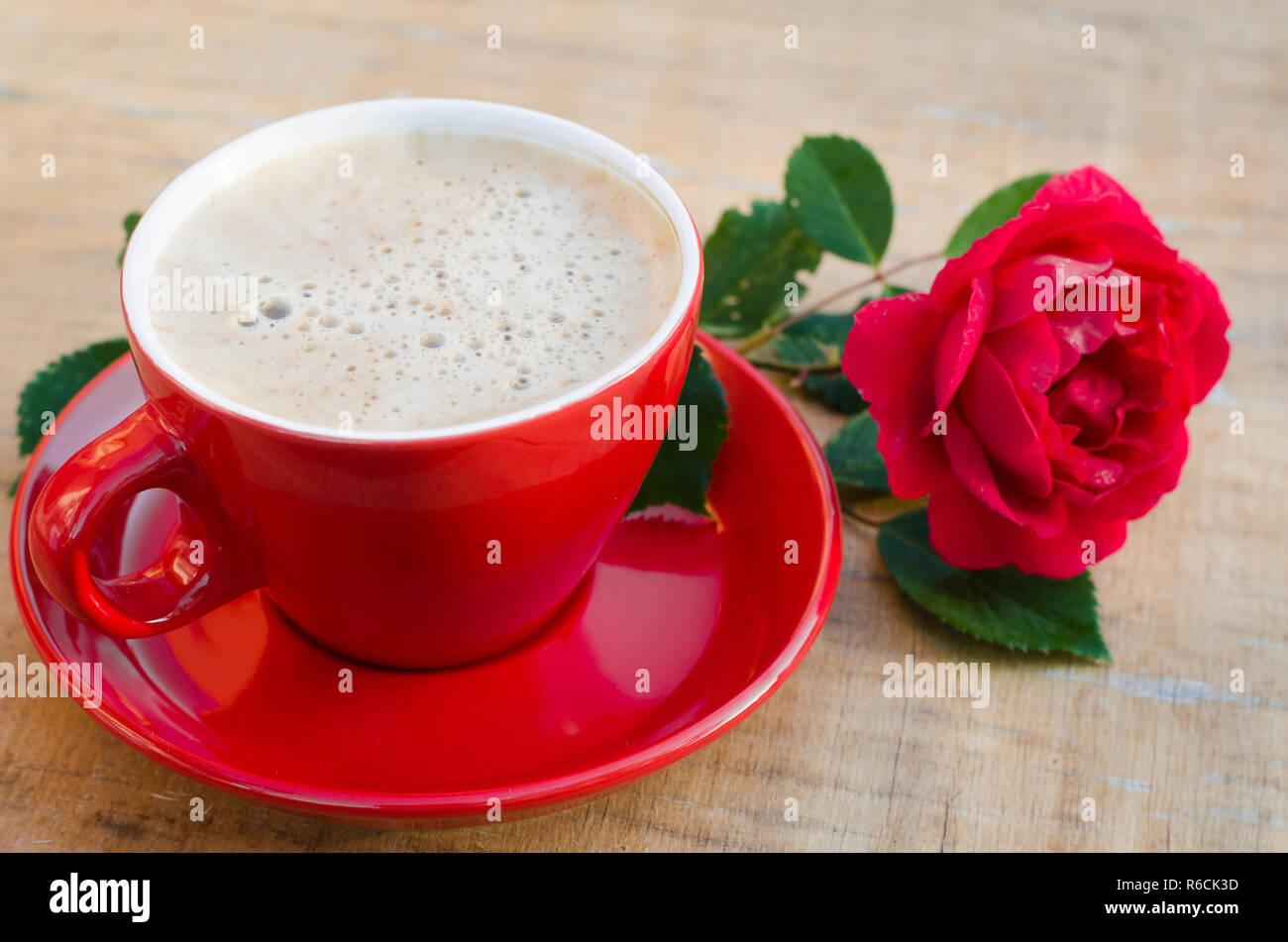Red cup of morning coffee or cappuccino and rose Stock Photo - Alamy