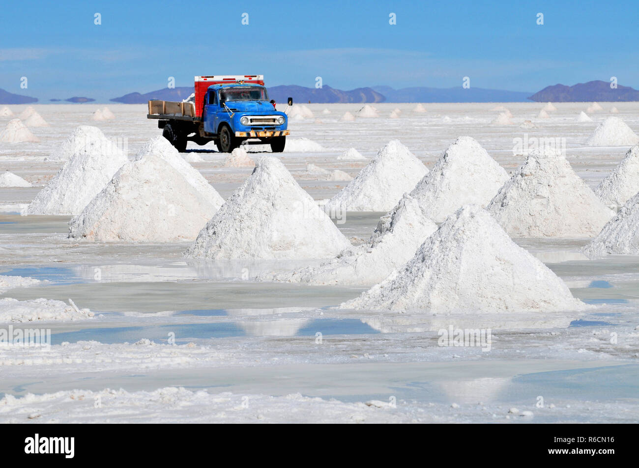 Piles Of Drying Salt And Reflection In The Water At The Salar De Uyuni ...
