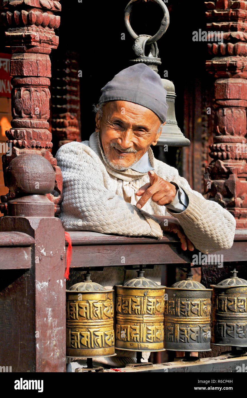 Nepal, Patan, Old Man And Prayer Wheels In Golden Temple Patan Buddhist ...