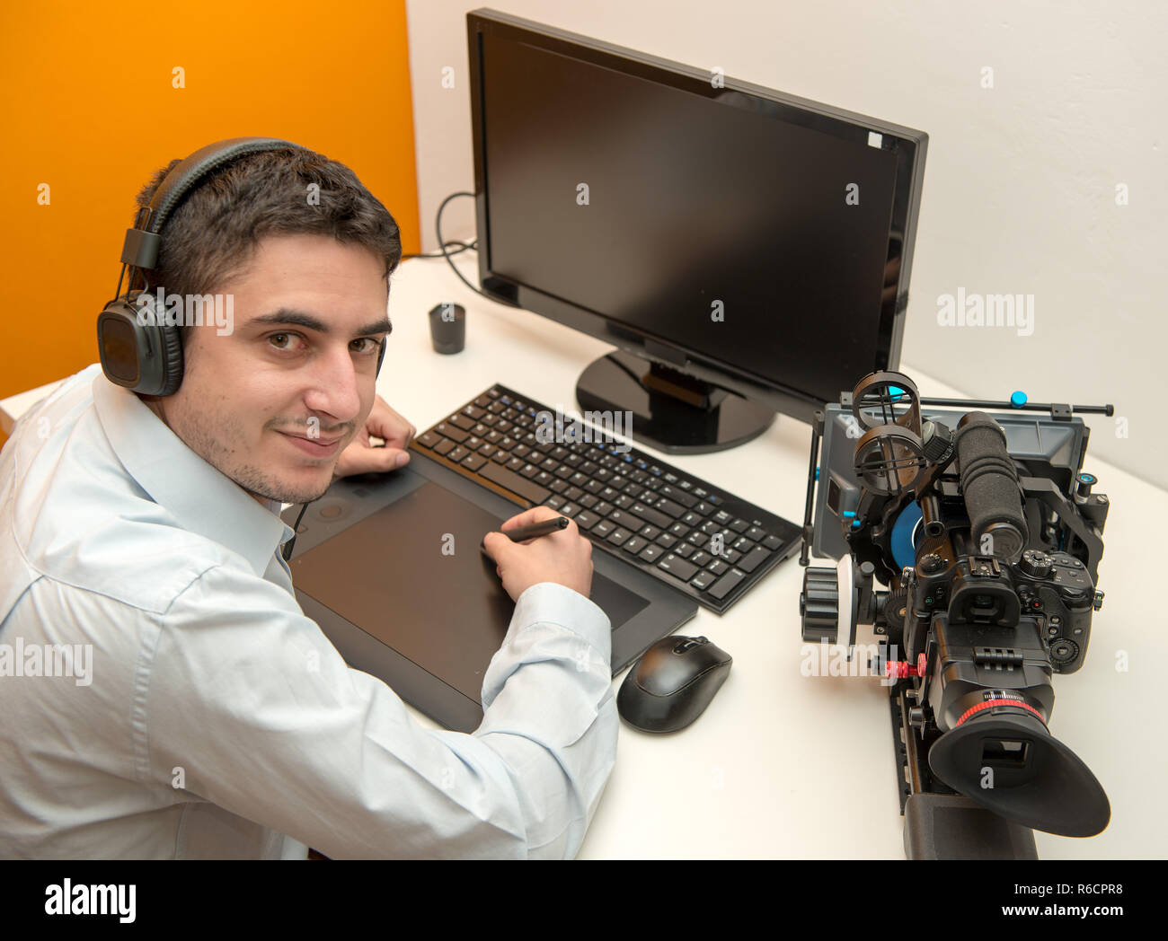 young man designer using graphics tablet for video editing Stock Photo ...