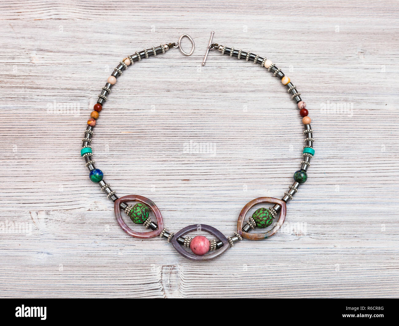 necklace from natural gemstones on wooden table Stock Photo - Alamy