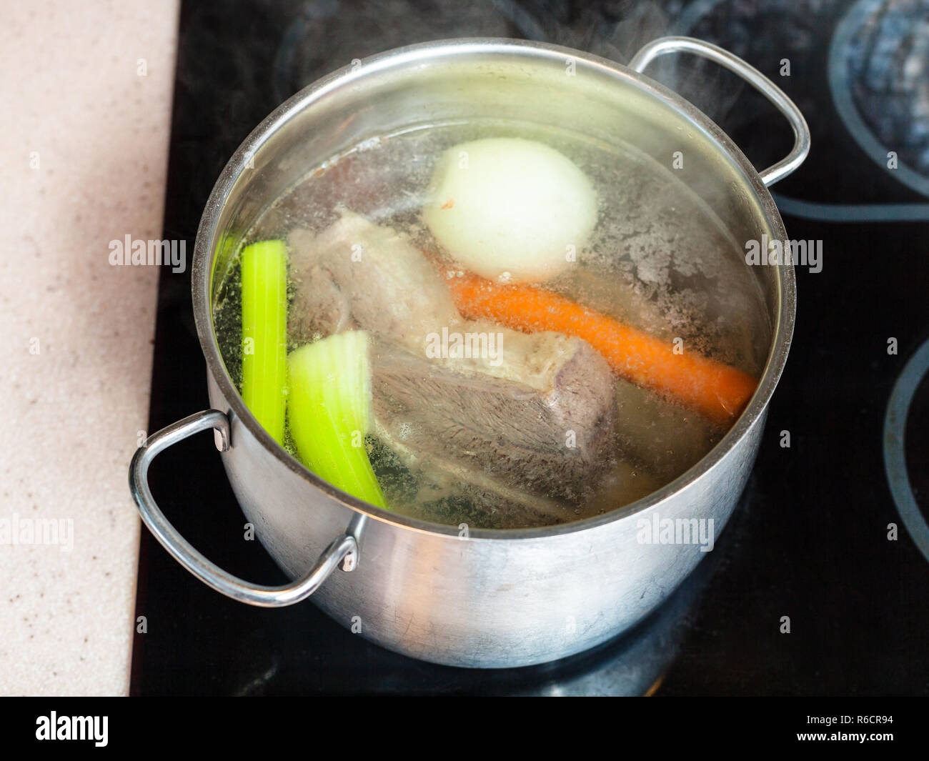Beef broth simmering in pot hi-res stock photography and images - Alamy