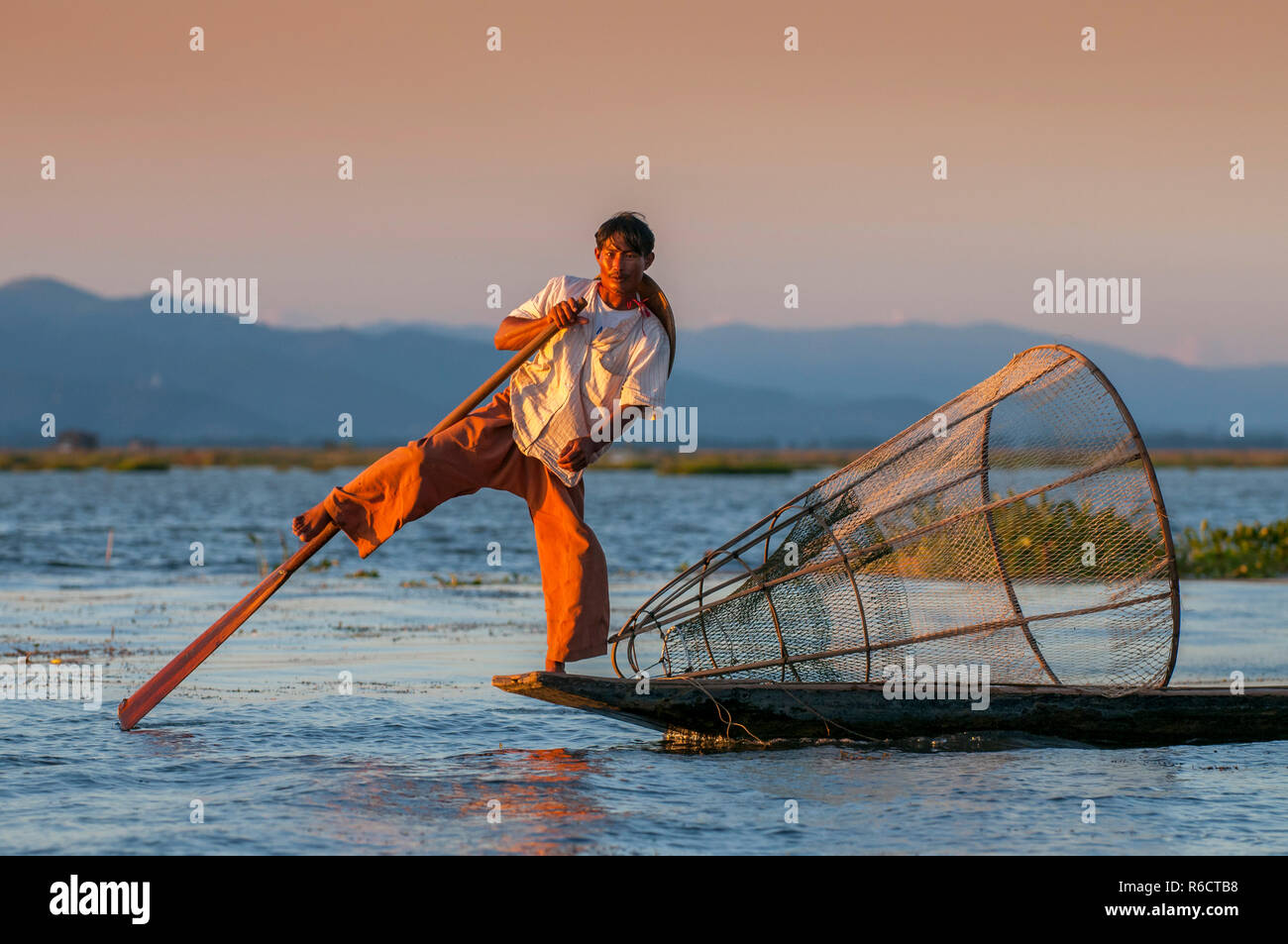 Traditional Burmese Fishermen With Fishing Net At Inle Lake In Myanmar ...
