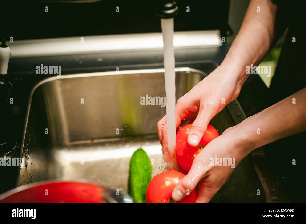 woman washing vegetables for cooking, water under the tap Stock Photo ...