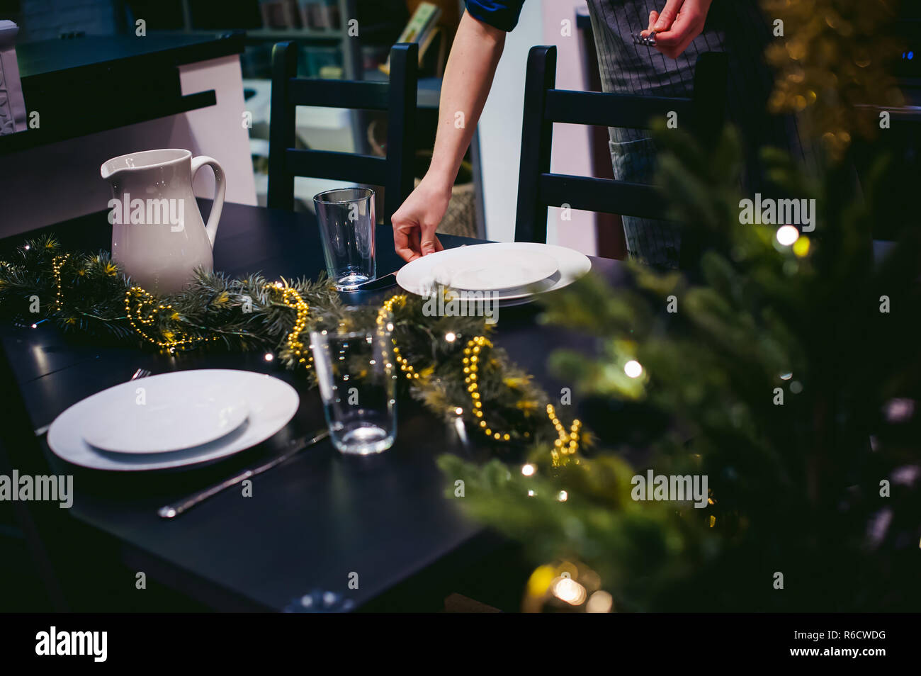 woman housewife setting the table. young blonde in a dress and apron ...