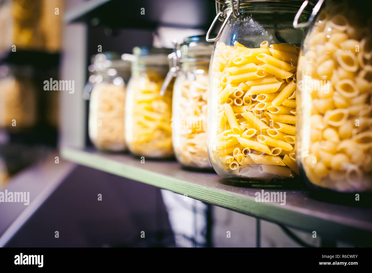 pasta in the jar. on kitchen shelves are different kinds of pasta in ...