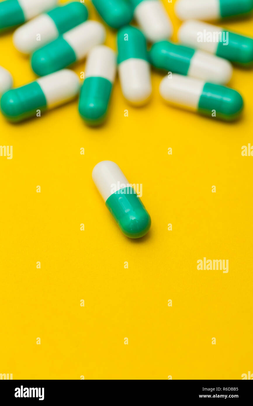 Prescription antibiotic drug medication pills on a bright colourful ...