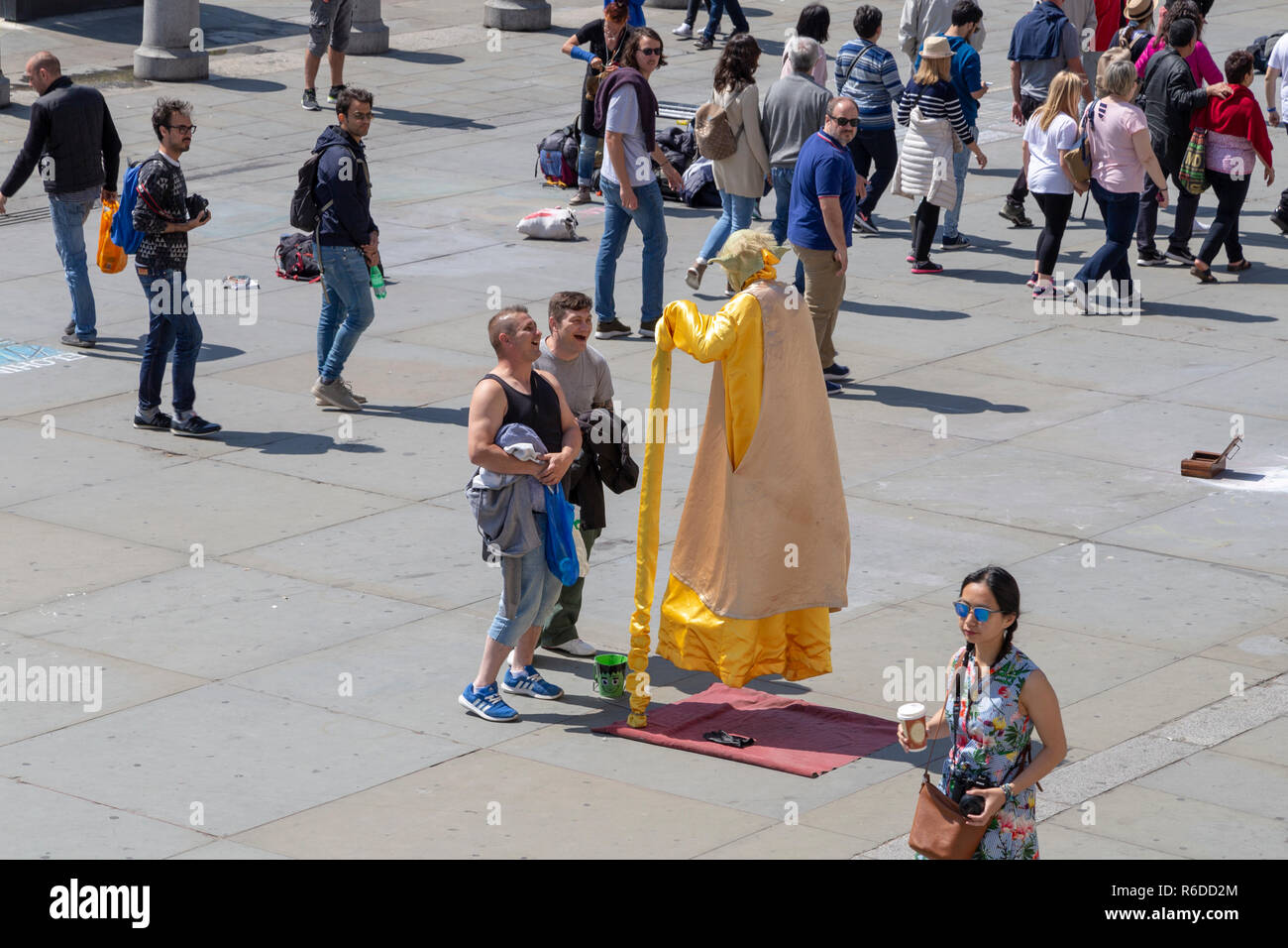 Street performer dressed as Yoda. The performer is creating the ...