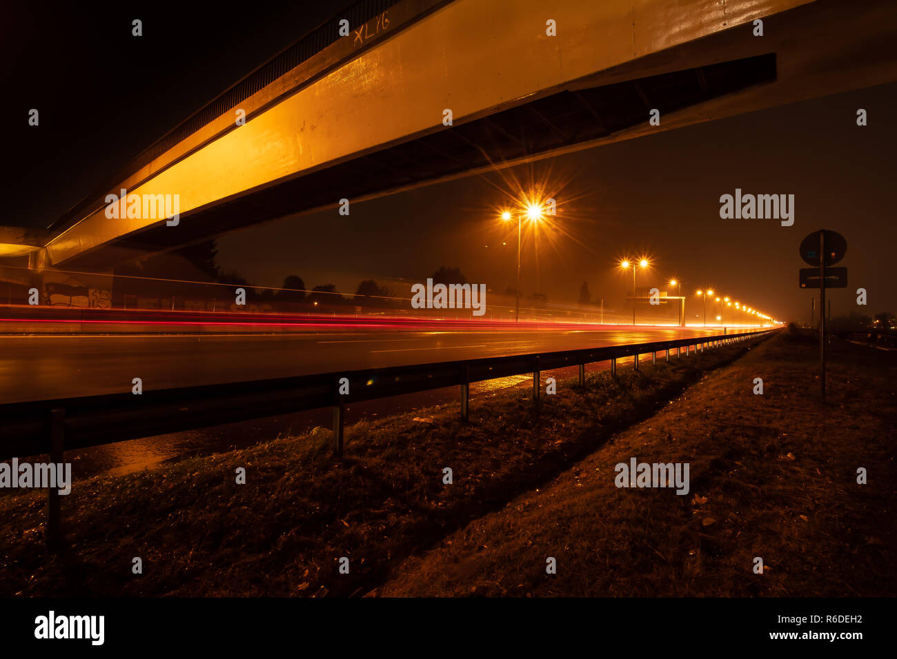 Highway With Bridge And Car Light Trails At Night Stock Photo - Alamy