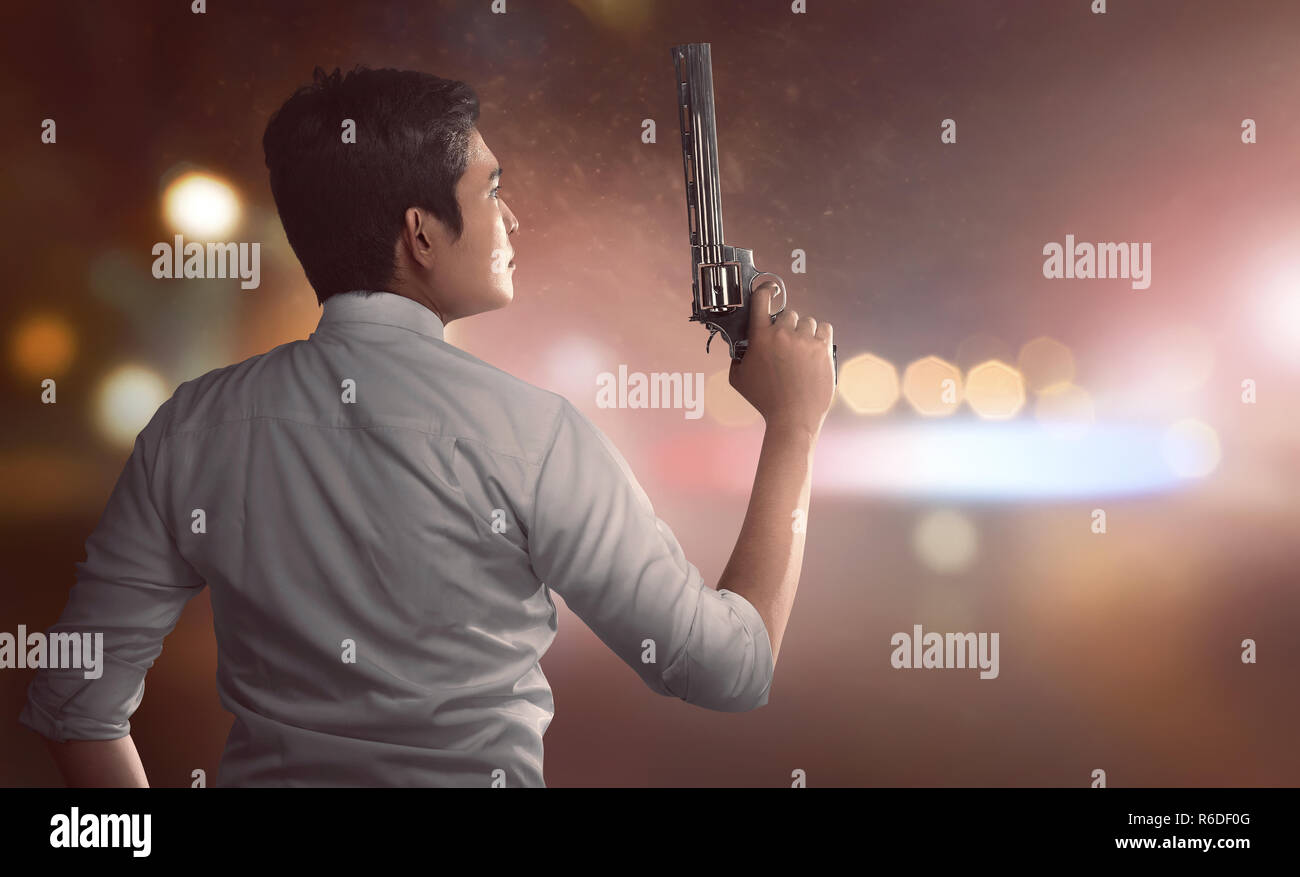 Young Handsome Man Holding Hand Gun High Resolution Stock Photography ...