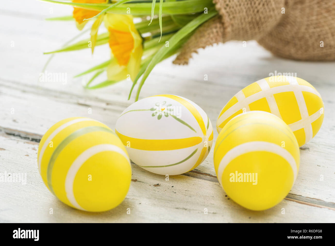 yellow easter eggs with daffodils Stock Photo - Alamy